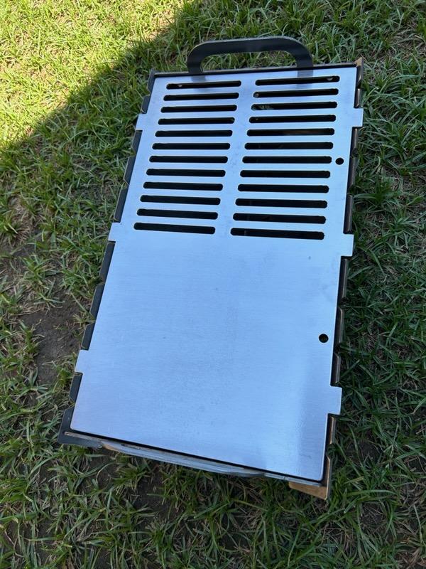 Mini steel grill with half grill and half griddle grate. Includes ...